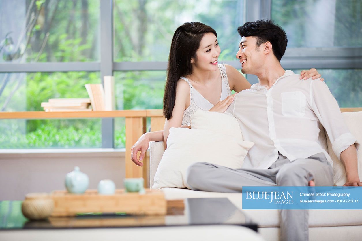 Young Chinese couple smiling at each other-High-res stock photo for download