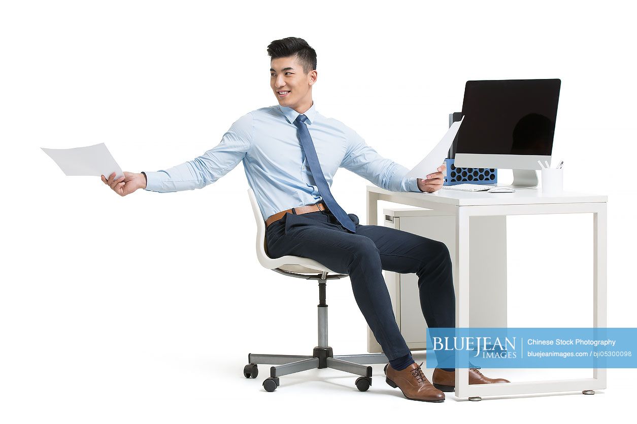 Cheering Young Chinese Businessman Working In Office High res Stock Cheering Young Chinese Businessman Working In Office High res Stock