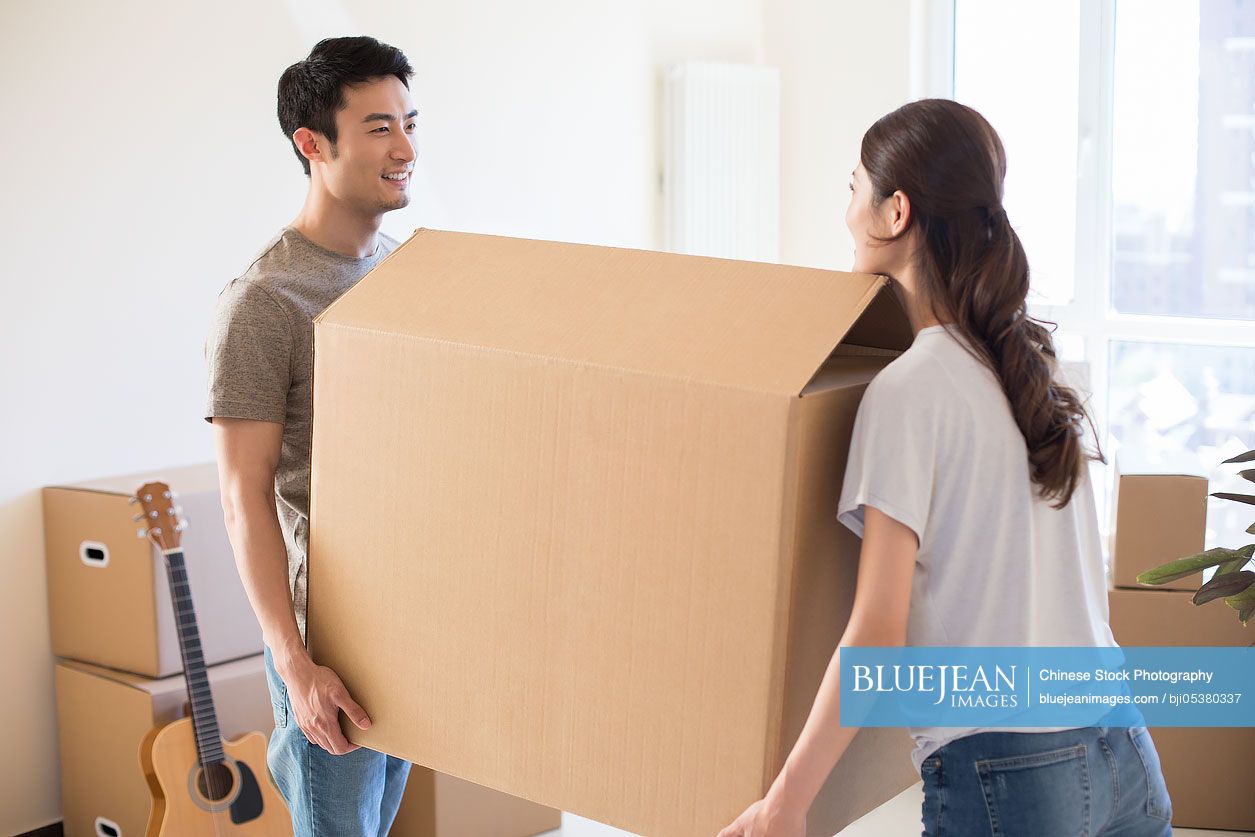 Happy young Chinese couple moving to a new house-High-res stock photo ...