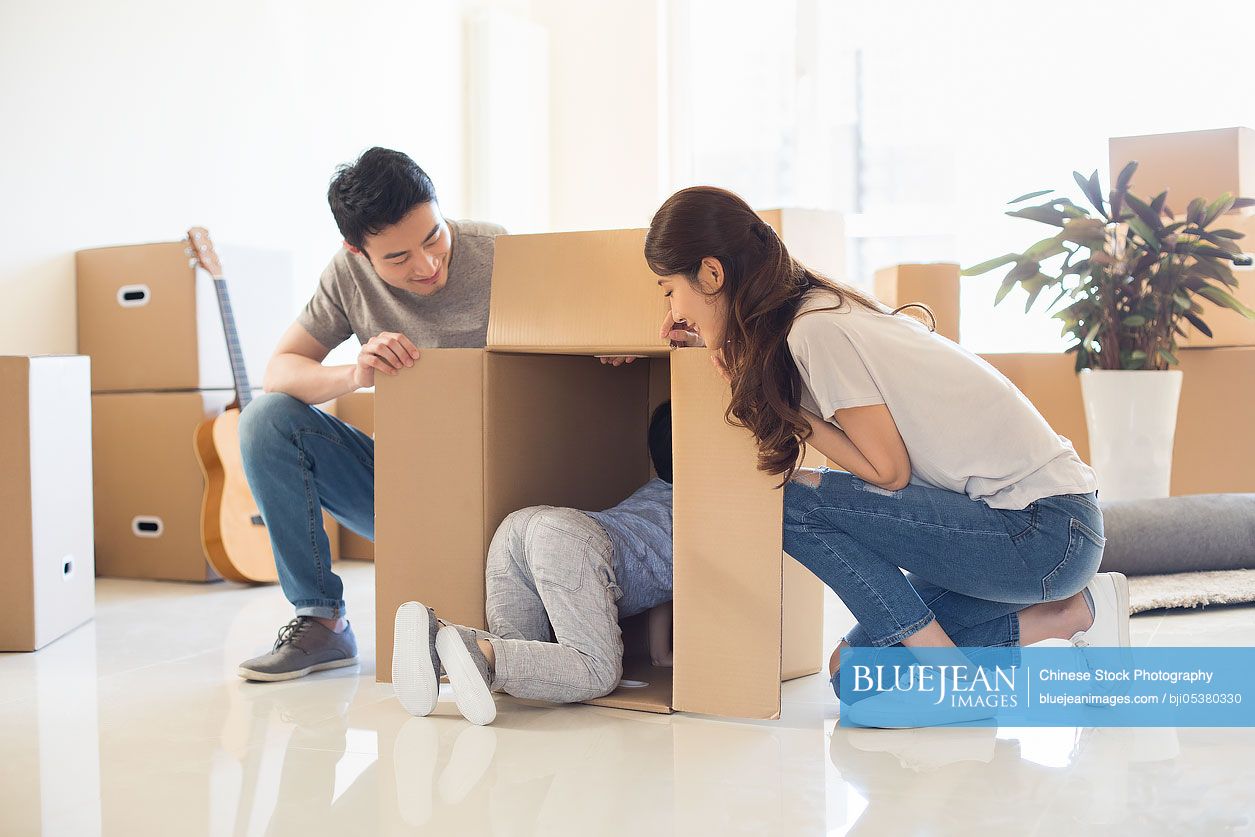 Happy young Chinese family moving to a new house-High-res stock photo ...