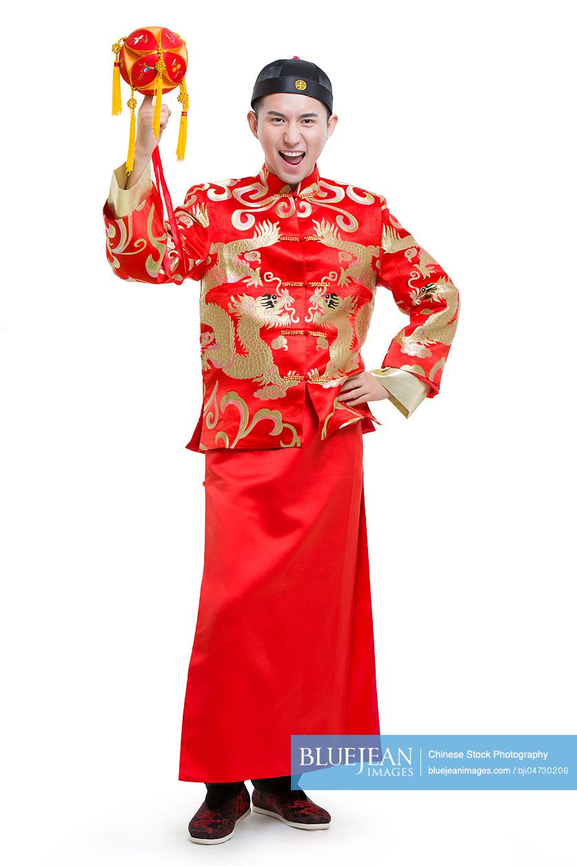 Young Chinese groom in Tang suit holding a embroider ball-High-res ...