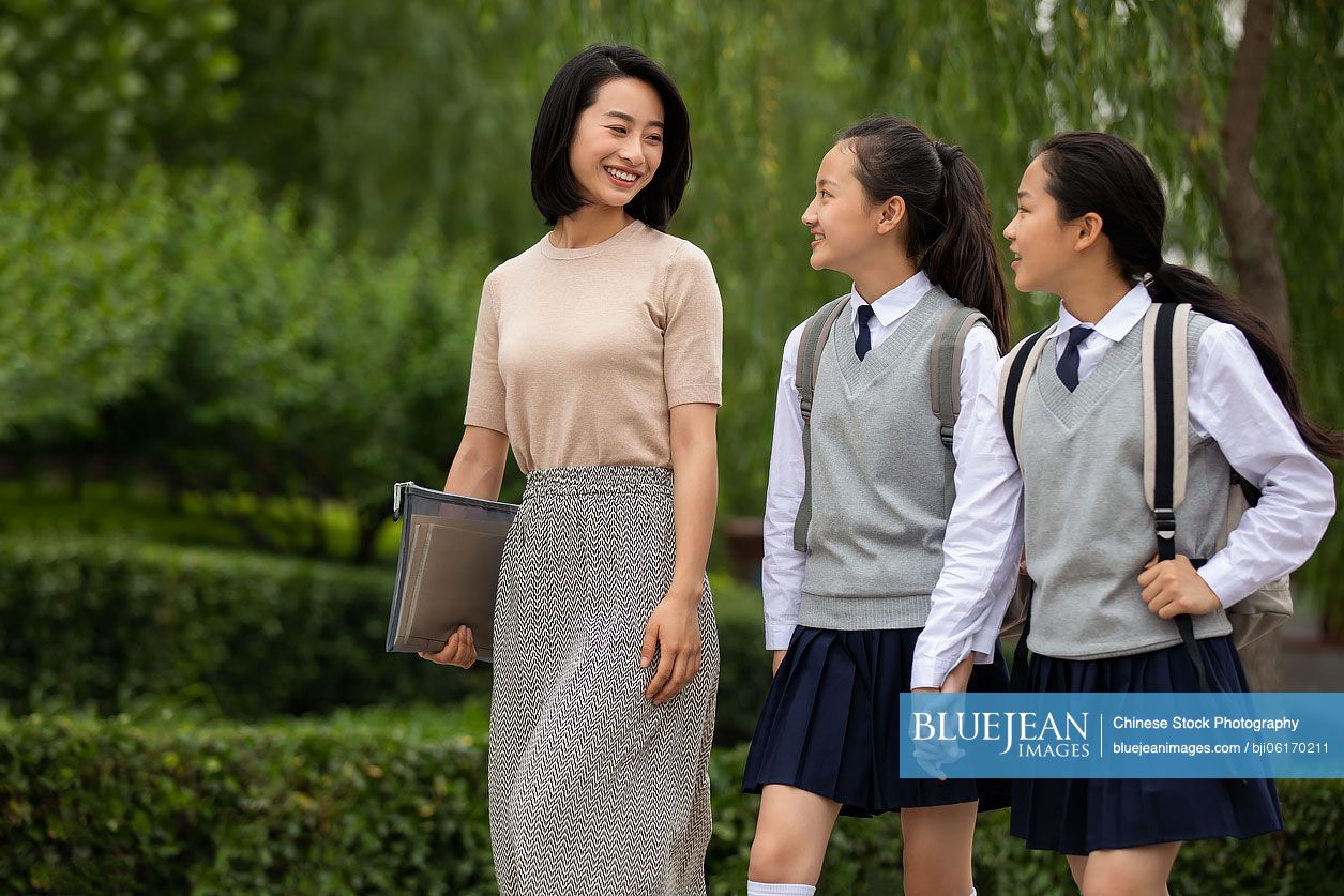 Chinese teacher talking with student on campus-High-res stock photo for ...
