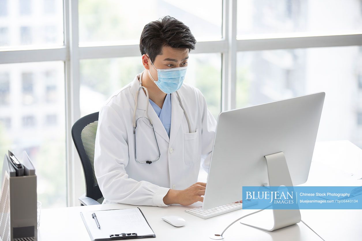 Young Chinese doctor using computer in doctor's office-High-res stock ...