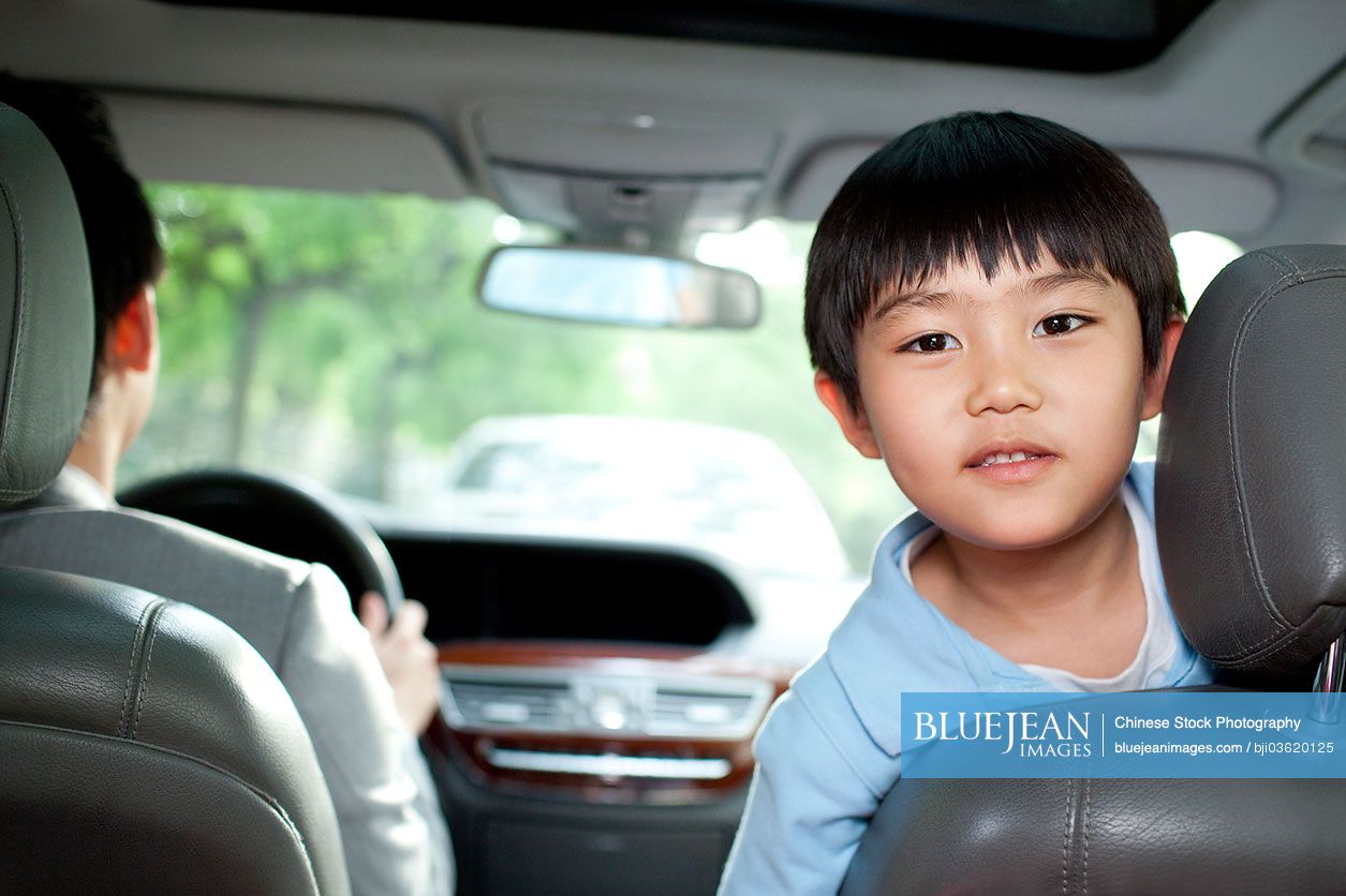 Chinese father driving with son in front seat-High-res stock photo for ...