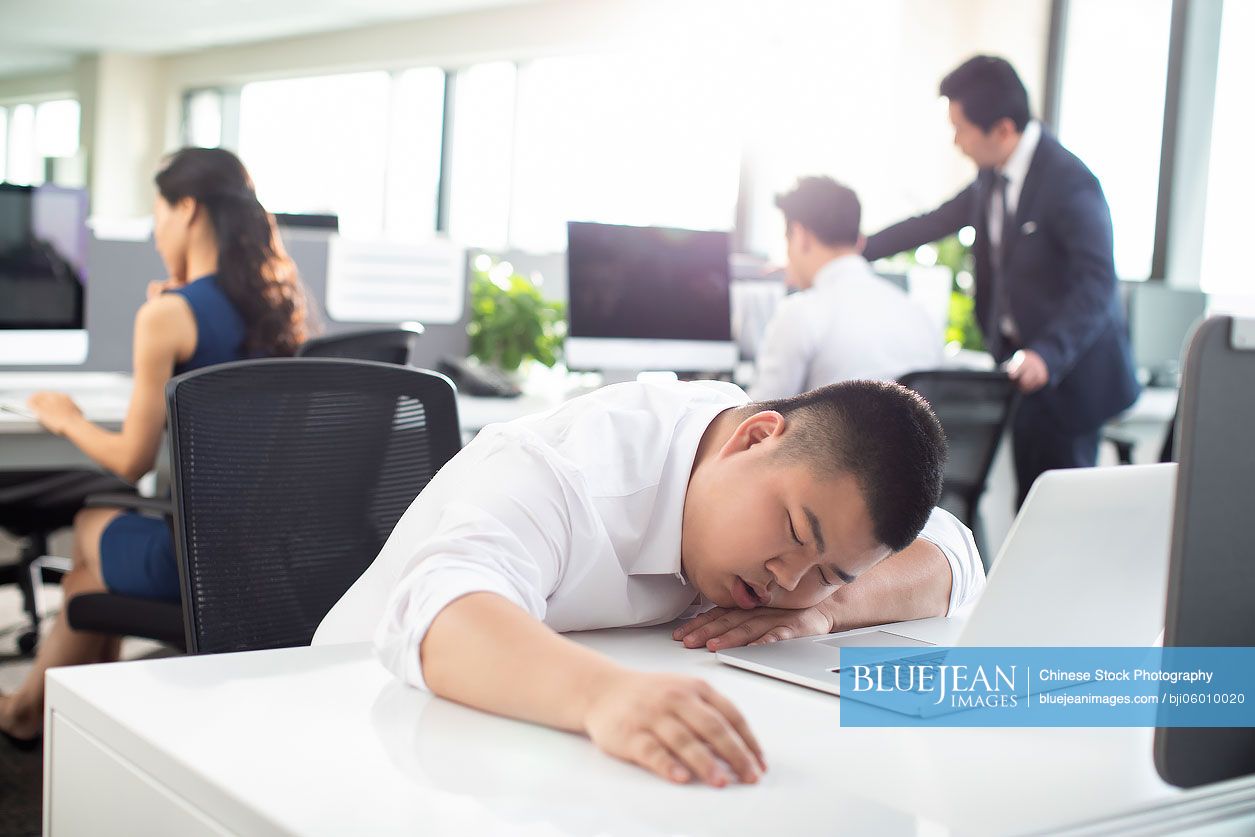 Chinese businessman napping in office hours-High-res stock photo for ...