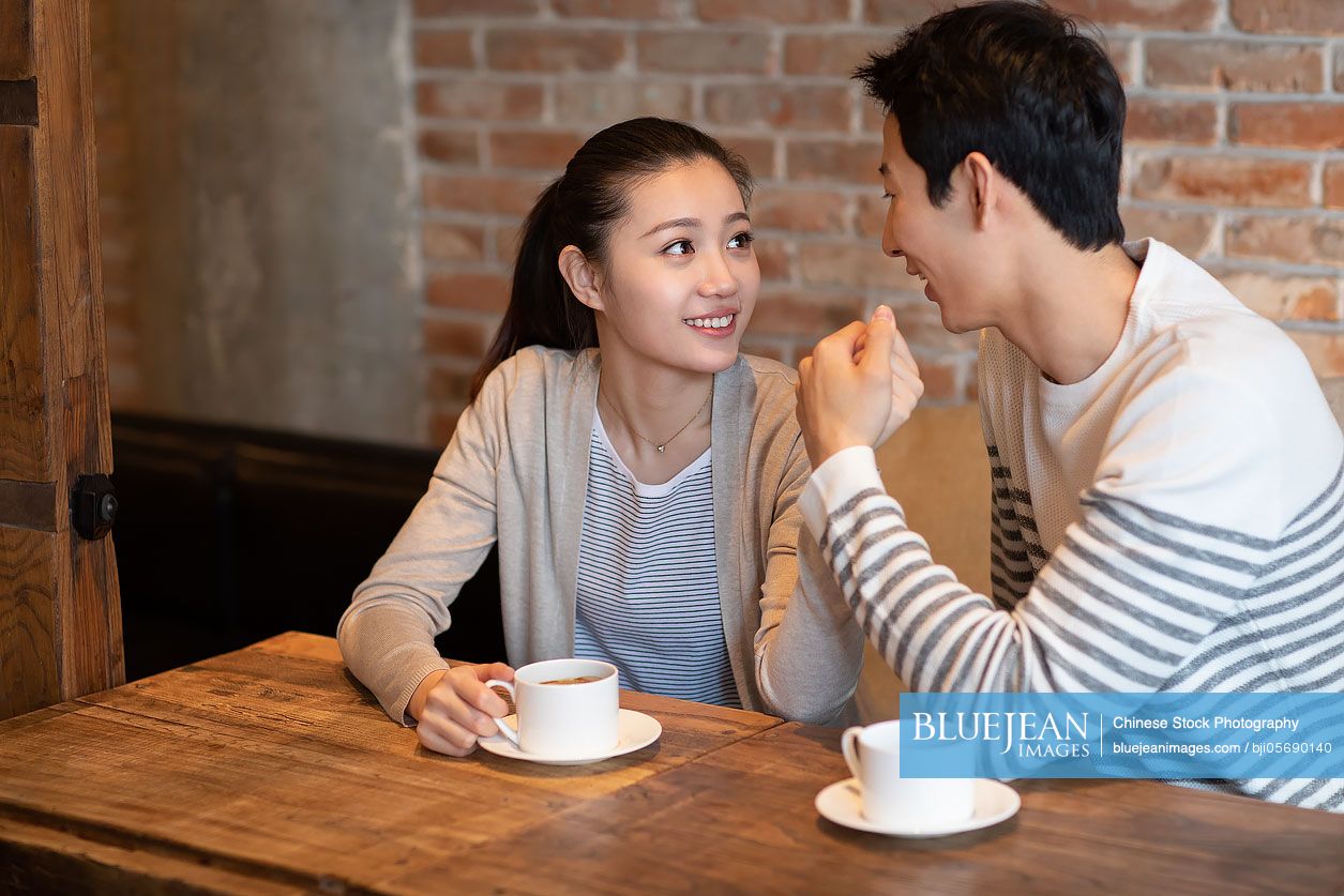 Young Chinese couple dating in coffee shop-High-res stock photo for ...