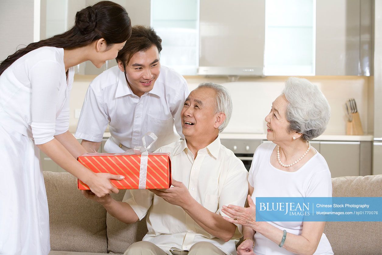 Senior Chinese man receives a gift from his family-High-res stock photo ...