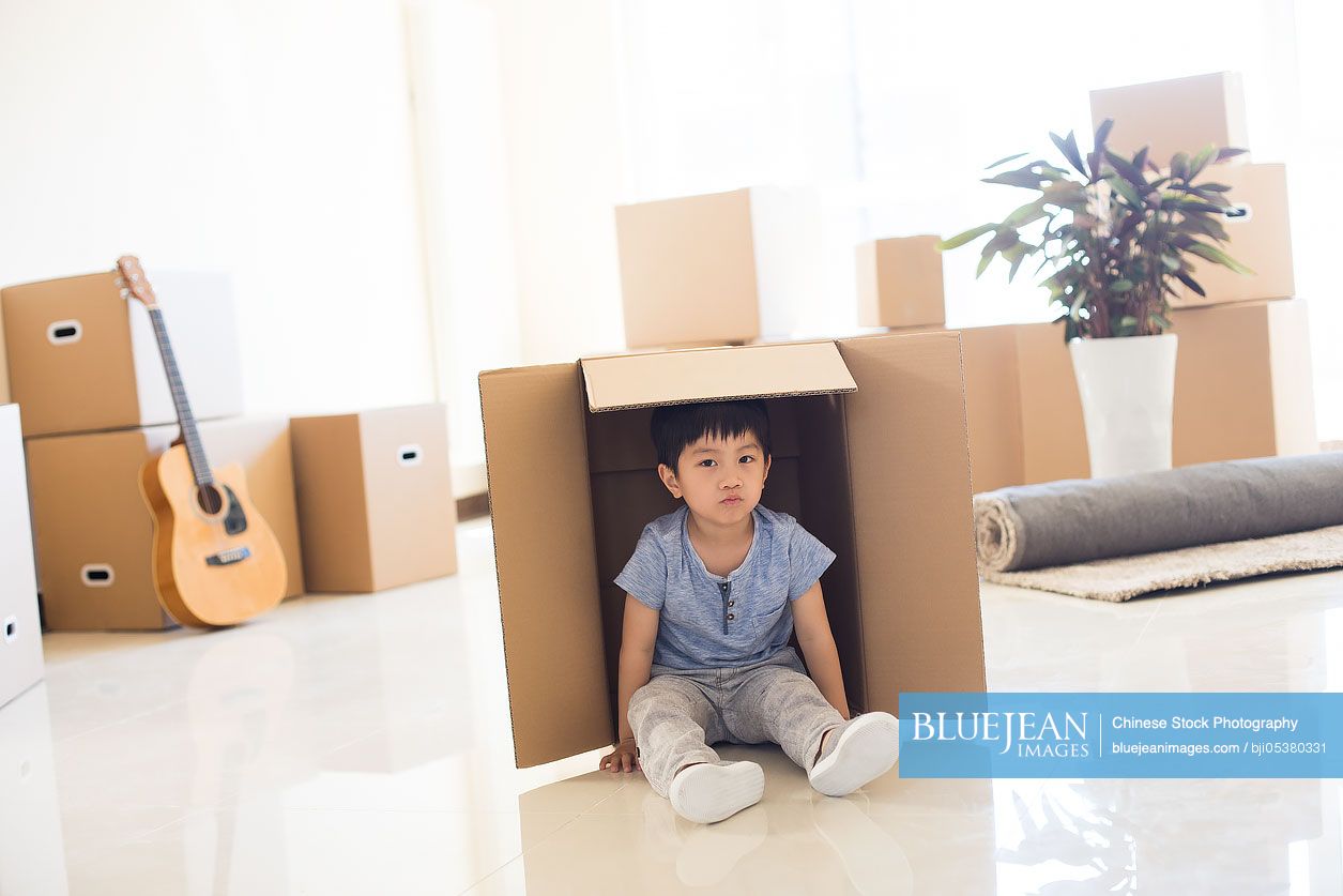 Chinese boy in a cardboard box-High-res stock photo for download