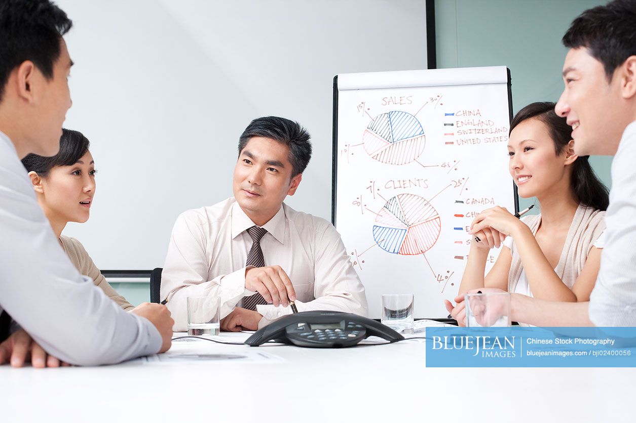 Chinese business executive listening to businessman's question-High-res ...