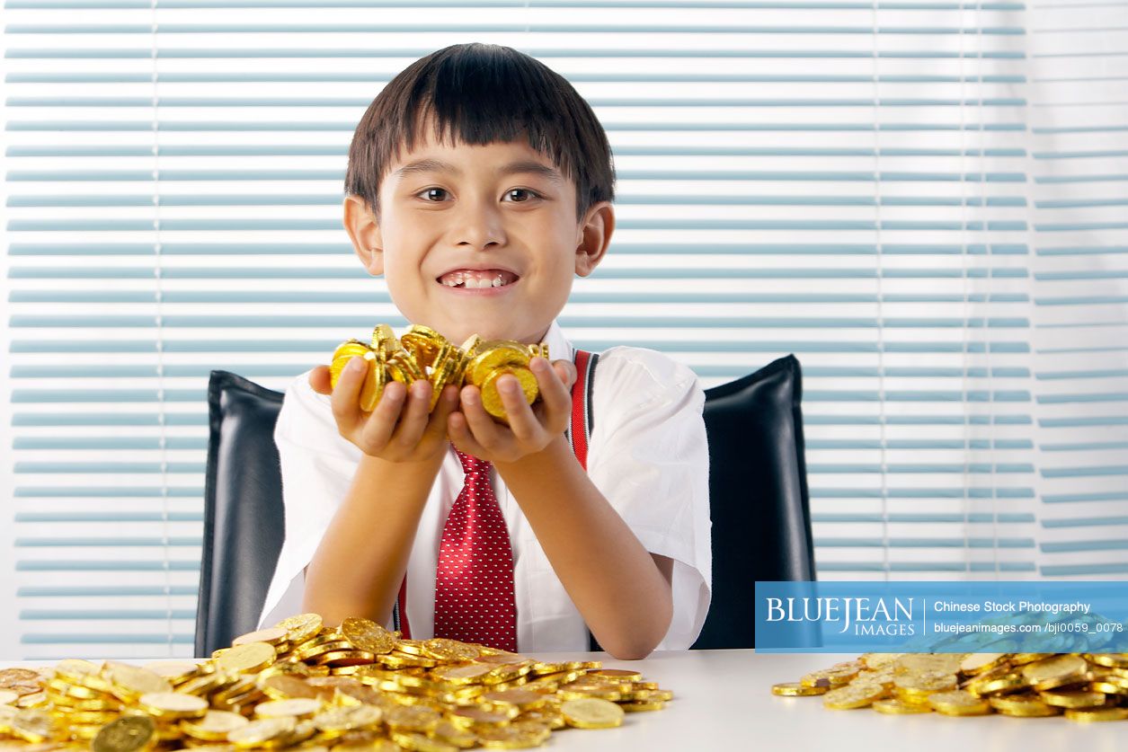 Young Boy With Gold Coins Smiling Happily-High-res stock photo for download