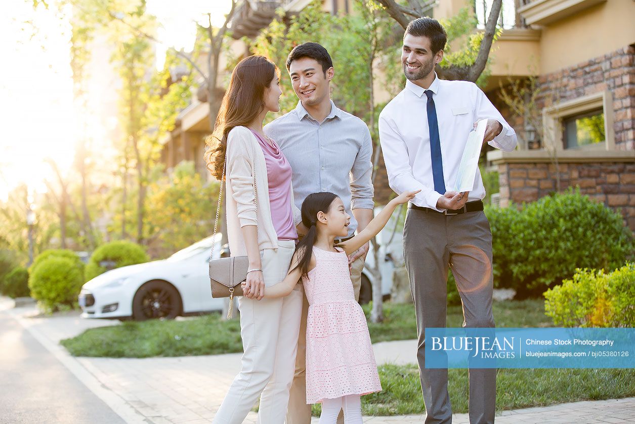 Happy young Chinese family and real estate agent-High-res stock photo ...