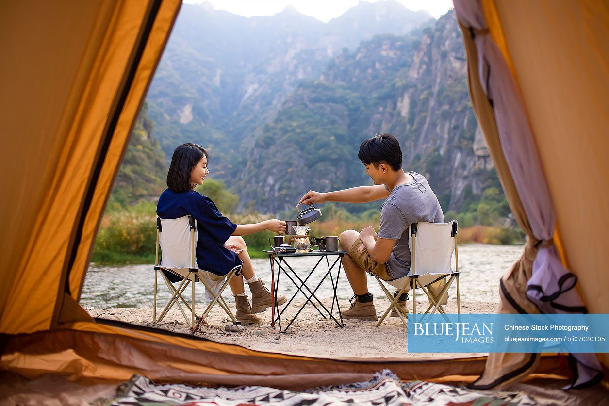 Happy young Chinese couple camping outdoors-High-res stock photo for ...