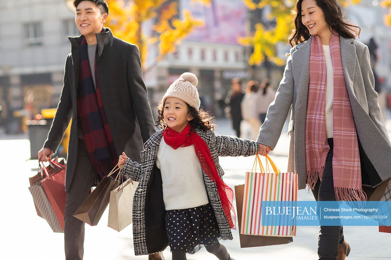 Happy young Chinese family shopping together-High-res stock photo for ...