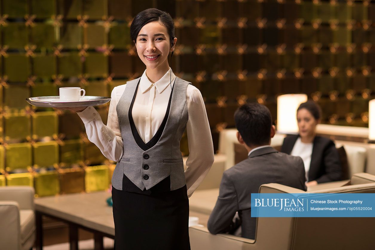 Cheerful young Chinese waitress serving coffee-High-res stock photo for ...