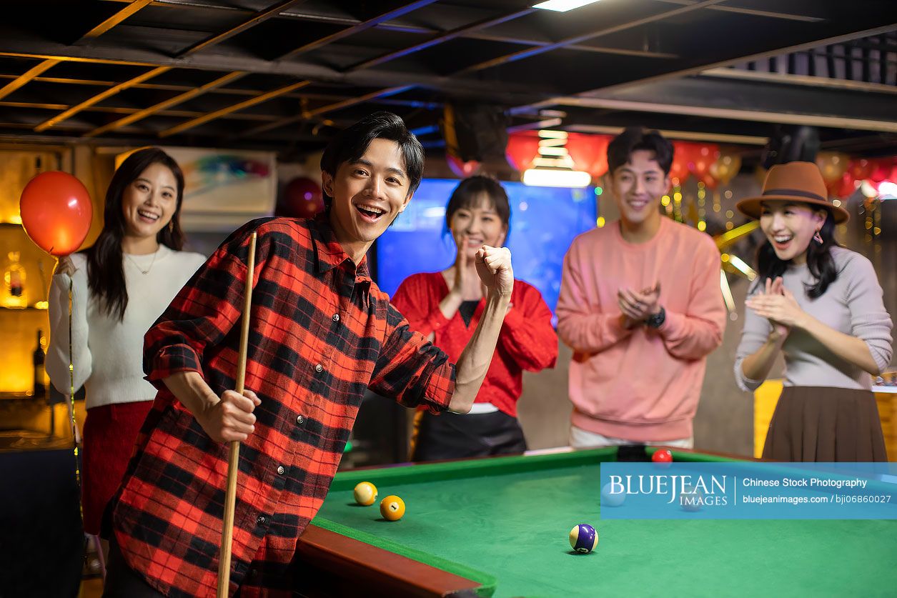 Happy Young Chinese Friends Playing Billiard Together High res Stock happy-young-chinese-friends-playing-billiard-together-high-res-stock