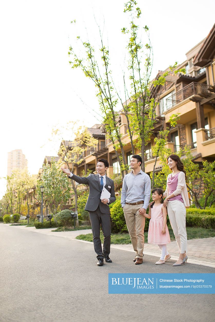 Happy young Chinese family talking with realtor-High-res stock photo ...