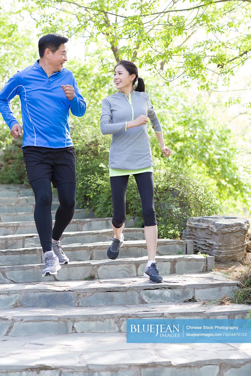 Happy mature Chinese couple running in park-High-res stock photo for download