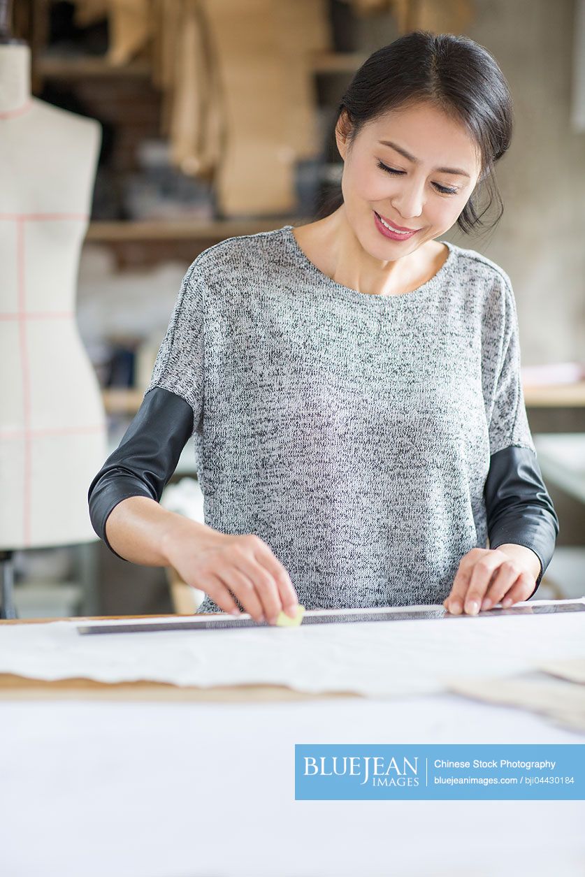 Chinese fashion designer working in studio-High-res stock photo for ...