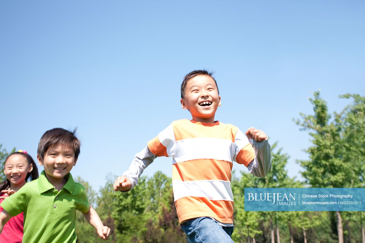 Chinese children running across field-High-res stock photo for download