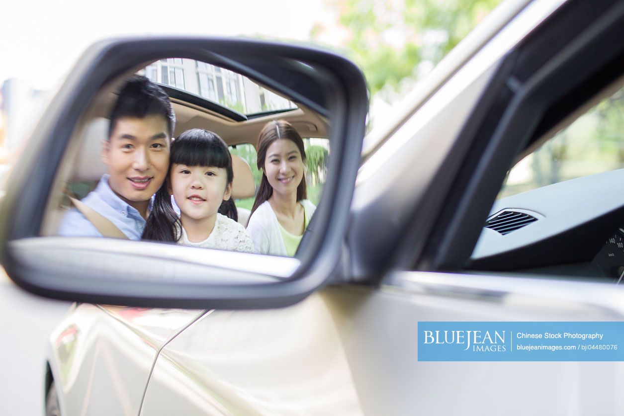 Happy young Chinese family in a car-High-res stock photo for download