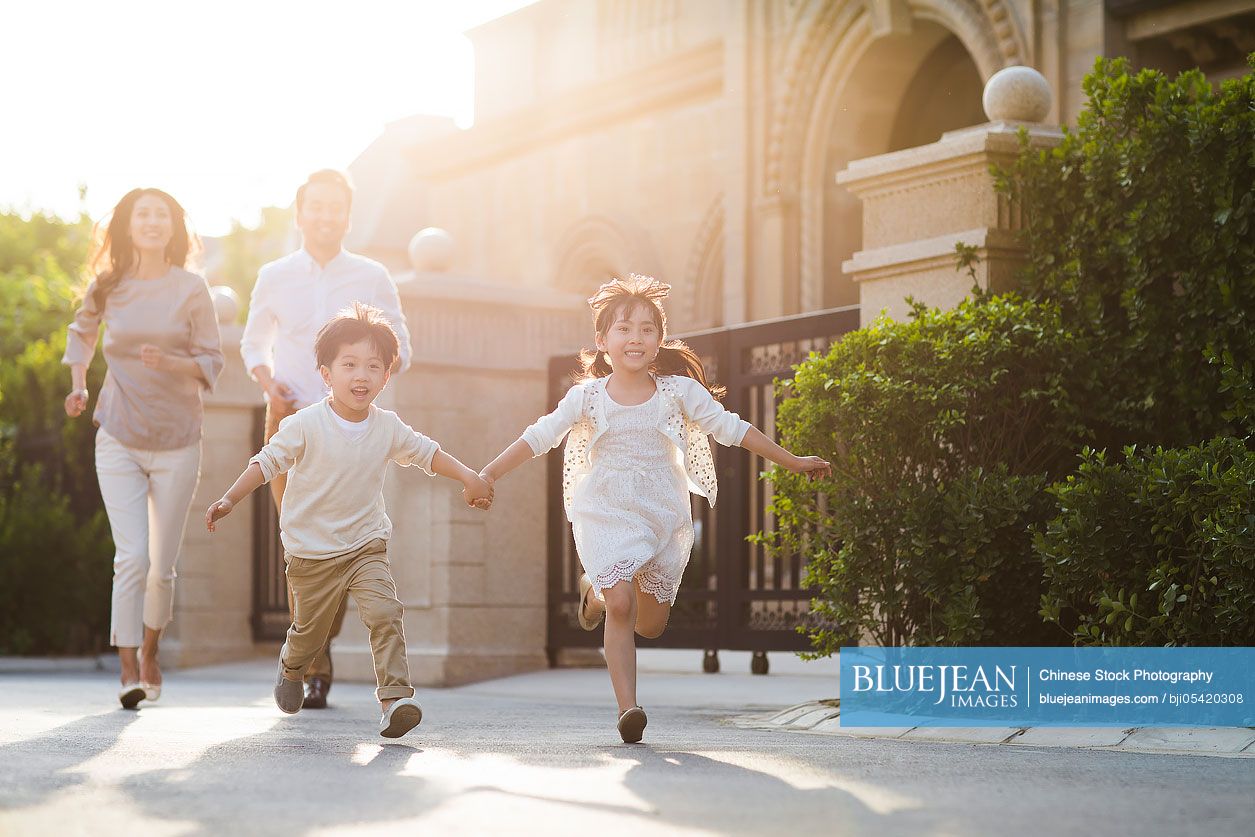 Happy young Chinese family playing outside-High-res stock photo for download