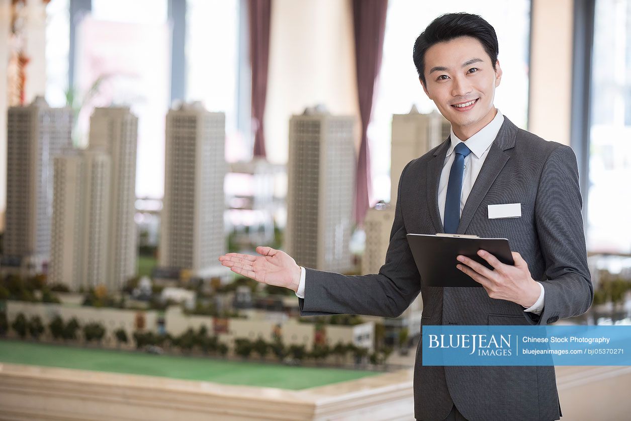 Confident Chinese male realtor greeting-High-res stock photo for download
