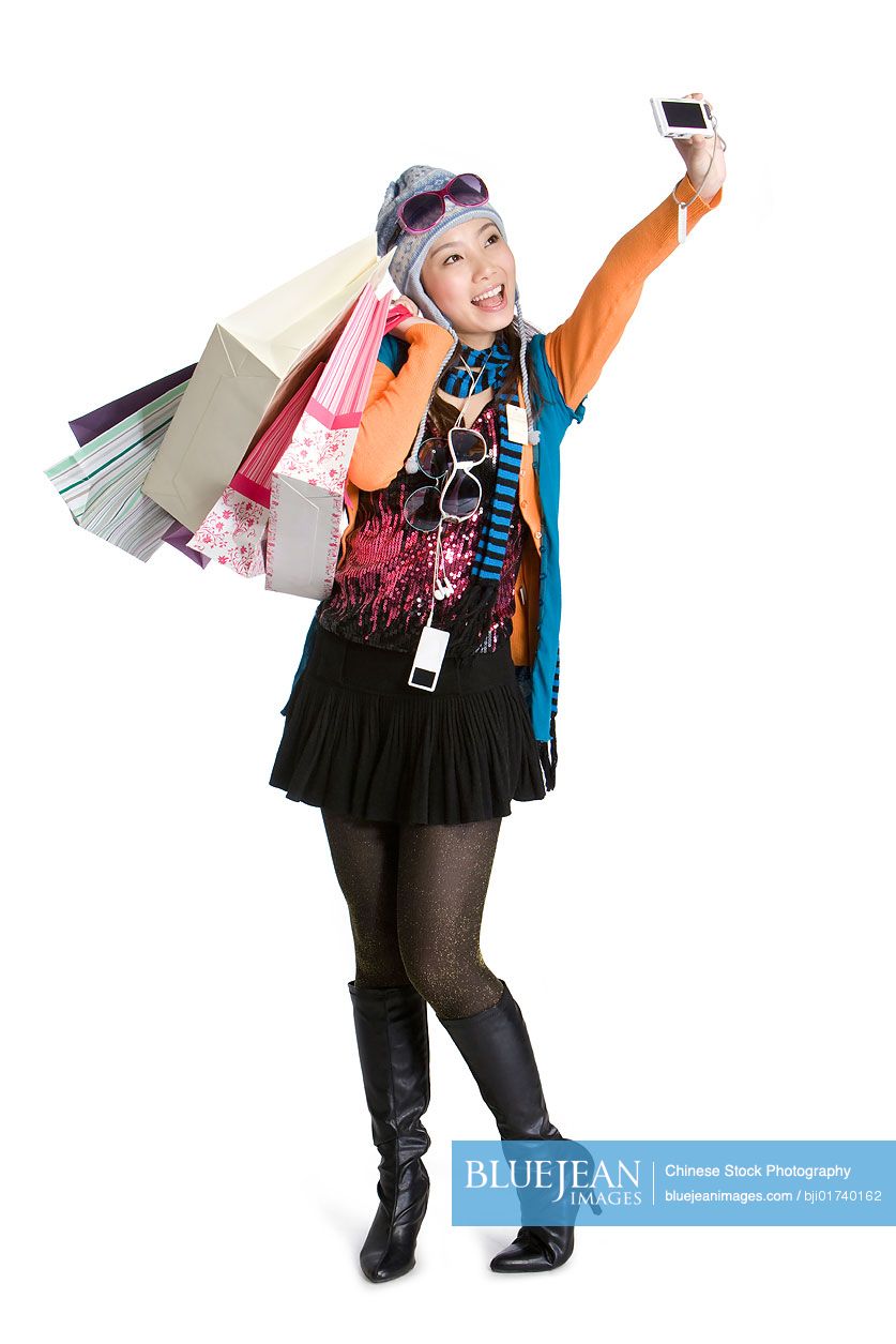 Young Chinese woman busy shopping-High-res stock photo for download