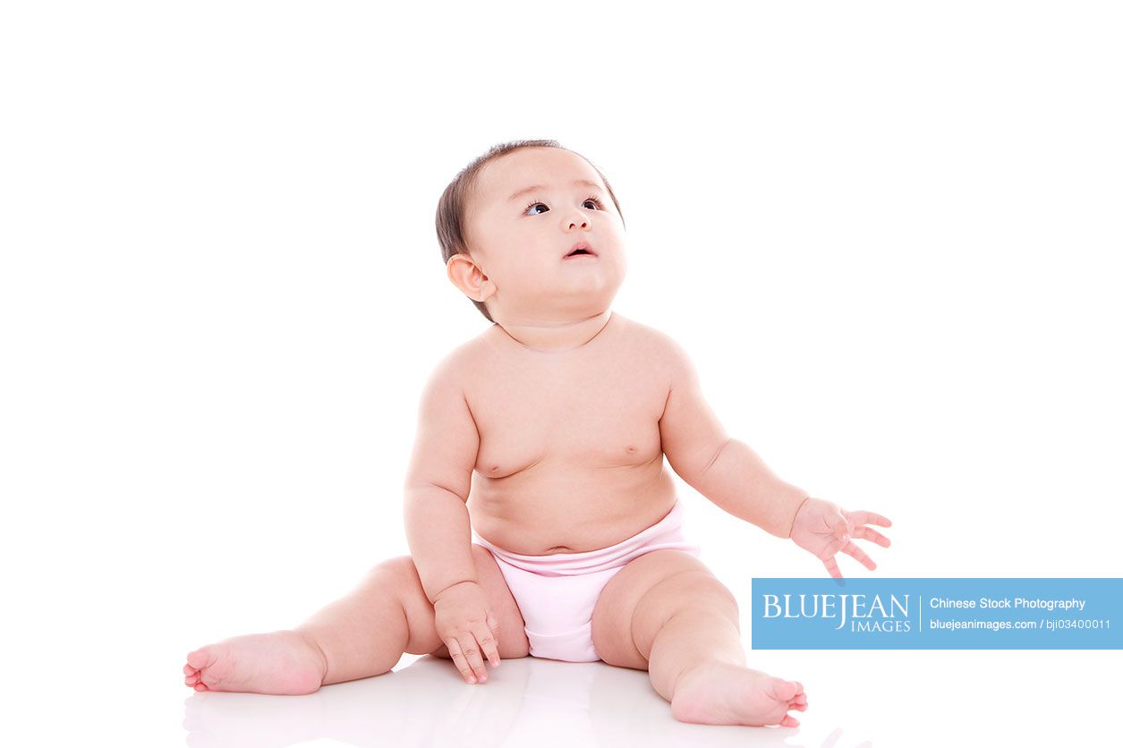 Studio shot of cute Chinese baby sitting on floor-High-res stock photo ...