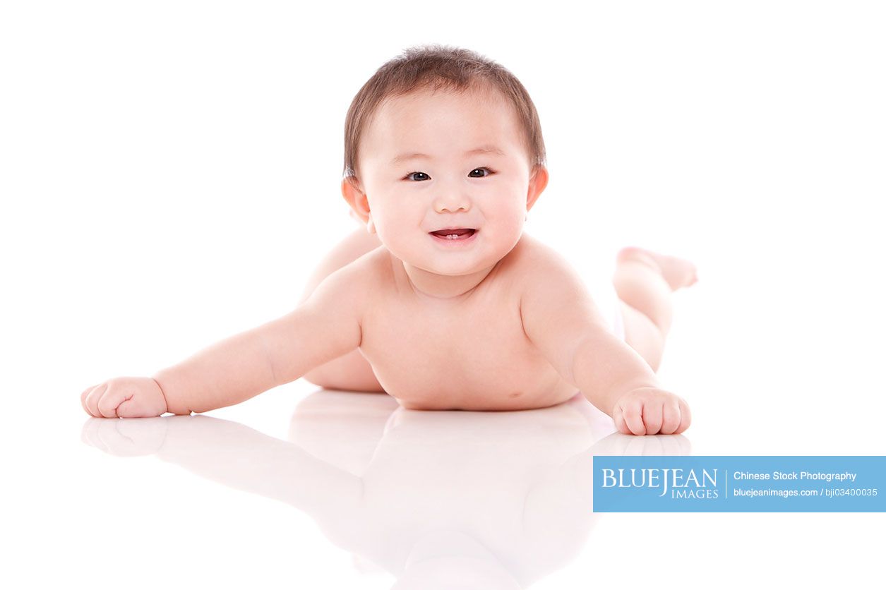 Studio shot of cute Chinese baby lying on floor-High-res stock photo ...
