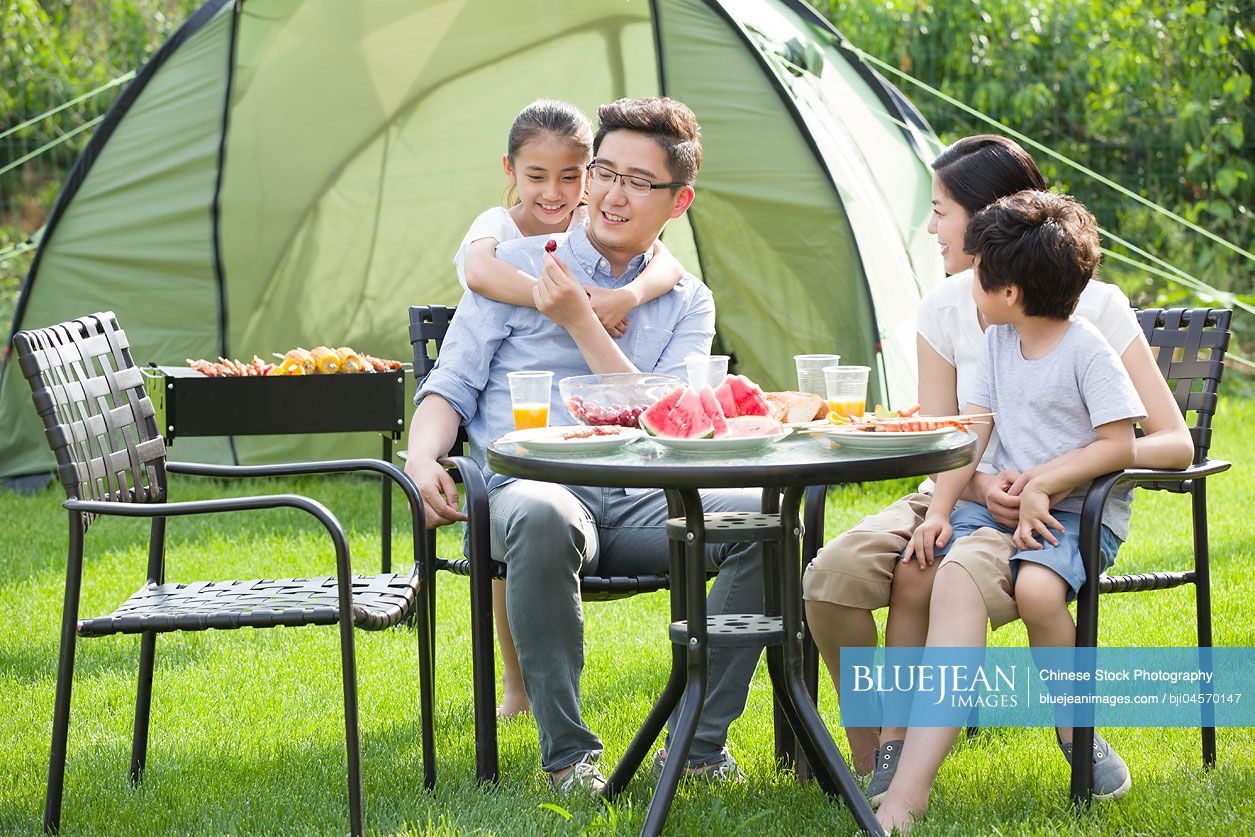 Young Chinese family picnicking outdoors-High-res stock photo for download