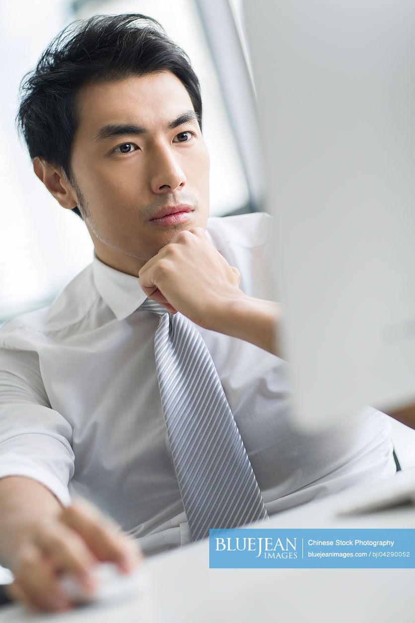 Young Chinese businessman using computer in office-High-res stock photo ...