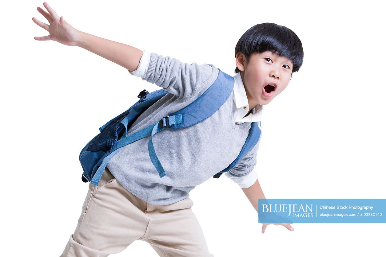 Excited Chinese boy with schoolbag on back-High-res stock photo for ...