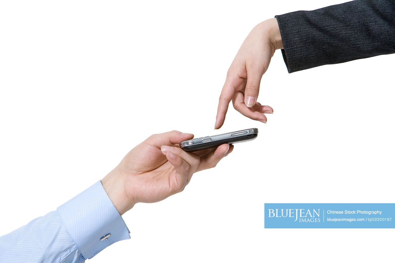 Reaching for a mobile phone-High-res stock photo for download