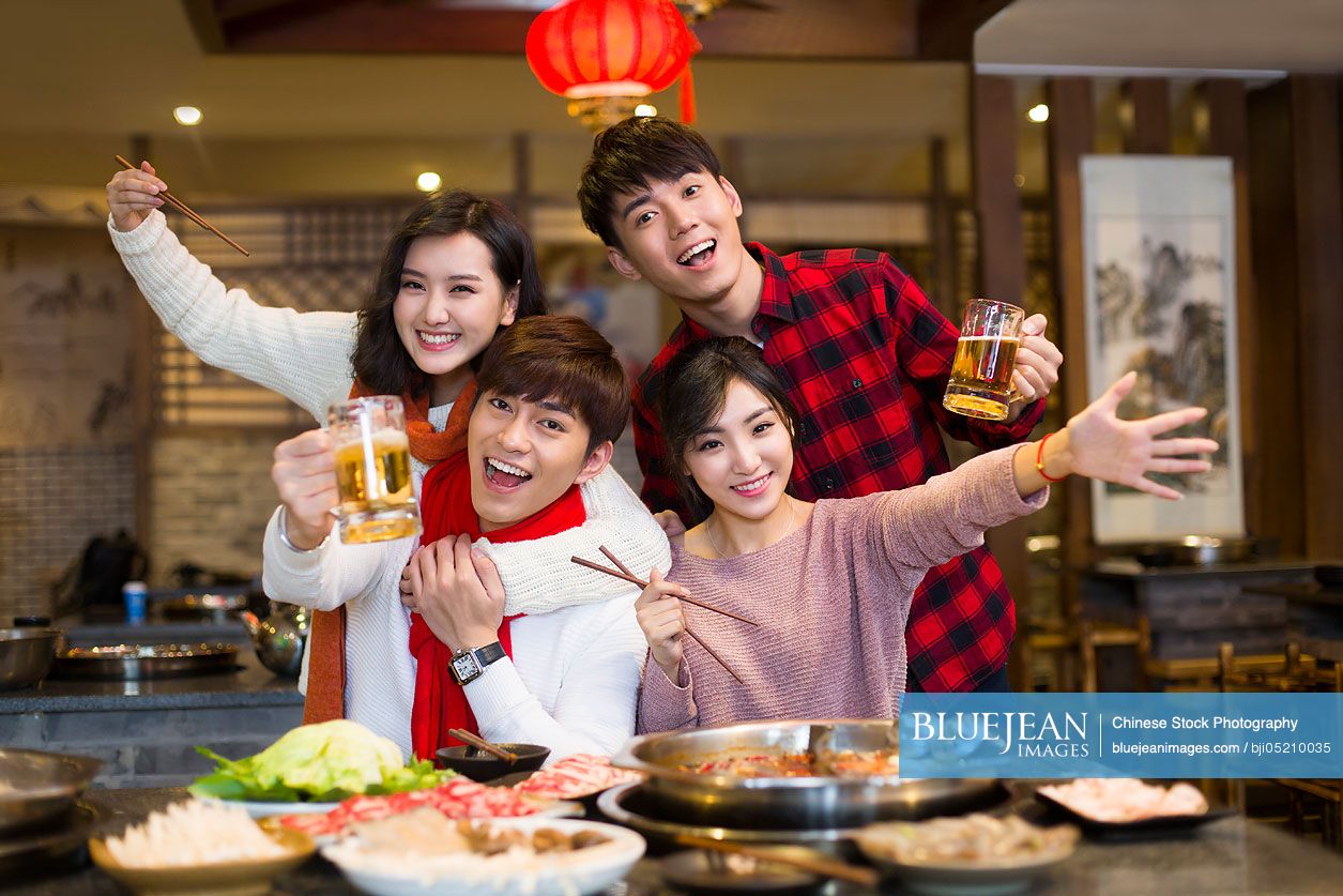 Young Chinese friends having dinner in hotpot restaurant-High-res stock ...