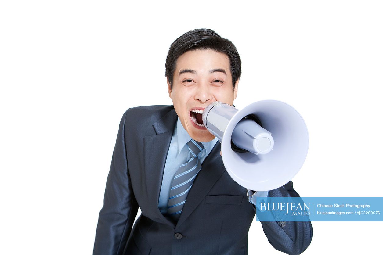 Portrait of a Chinese businessman shouting into a megaphone-High-res ...