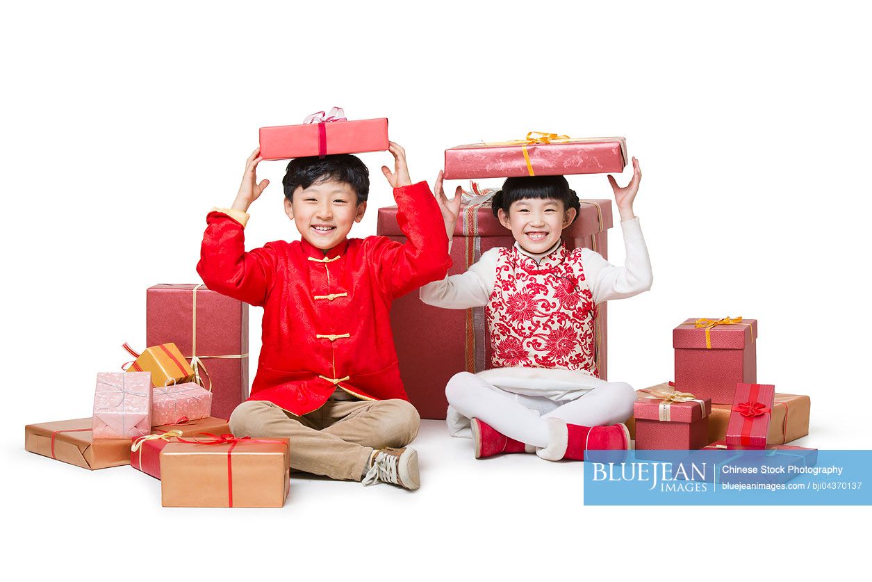 Happy children receiving many Chinese new year gifts-High-res stock ...