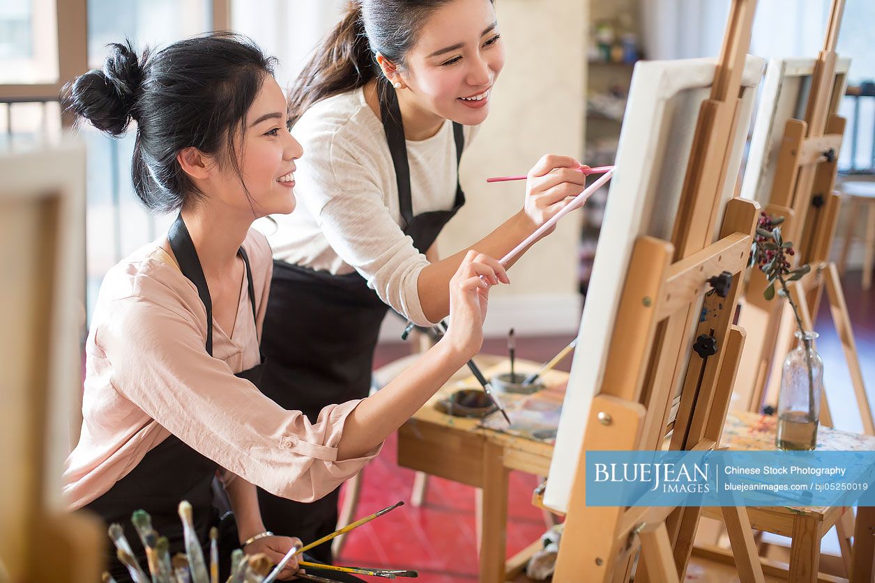 Young Chinese women painting in studio-High-res stock photo for download