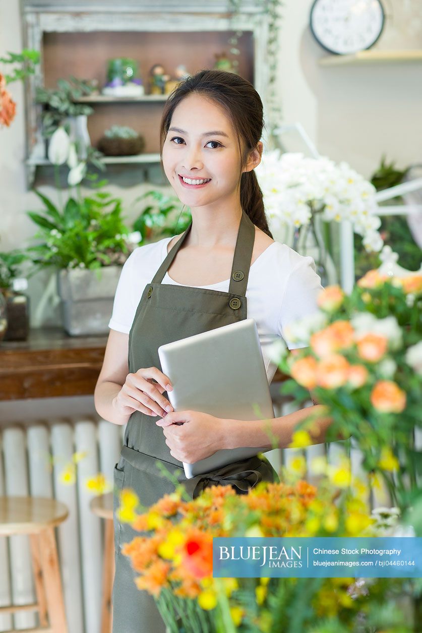 Female Chinese florist holding digital tablet in shop-High-res stock ...