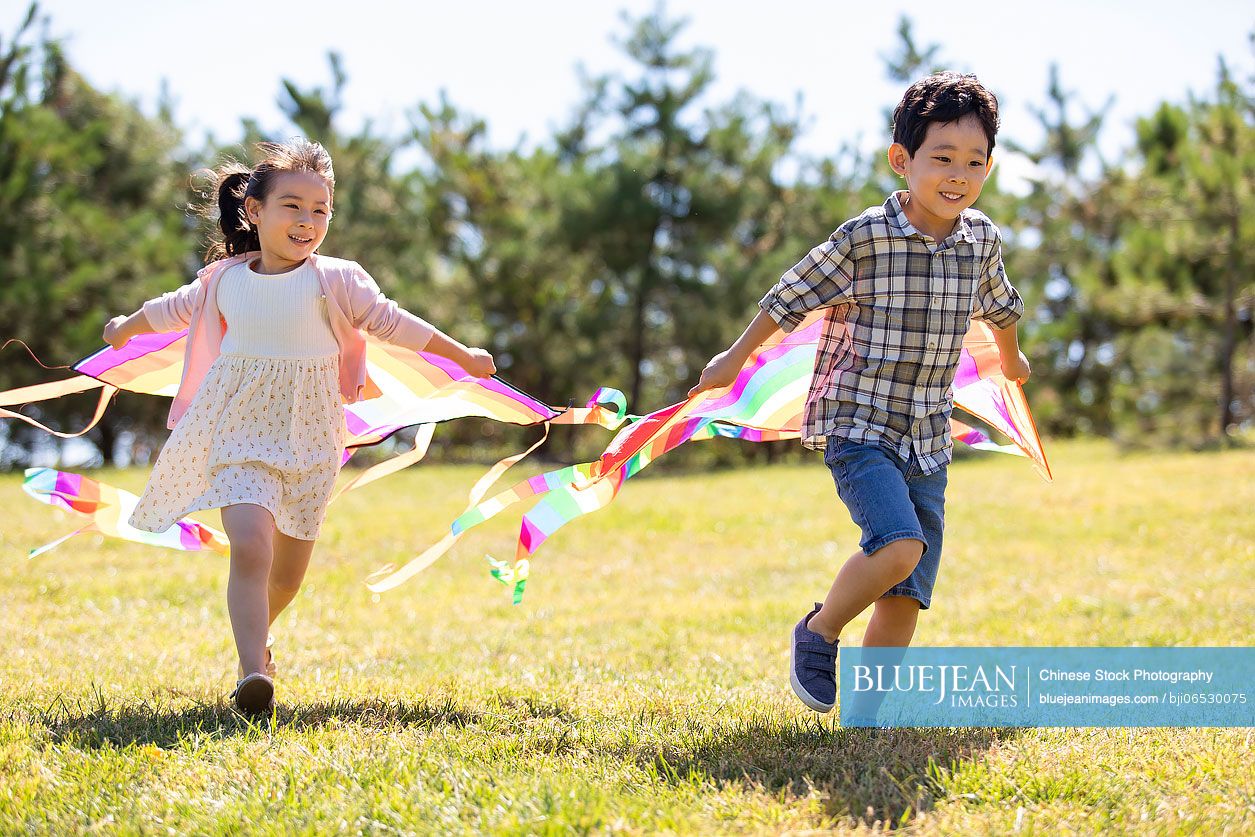 Happy Chinese children running with kites on meadow-High-res stock ...