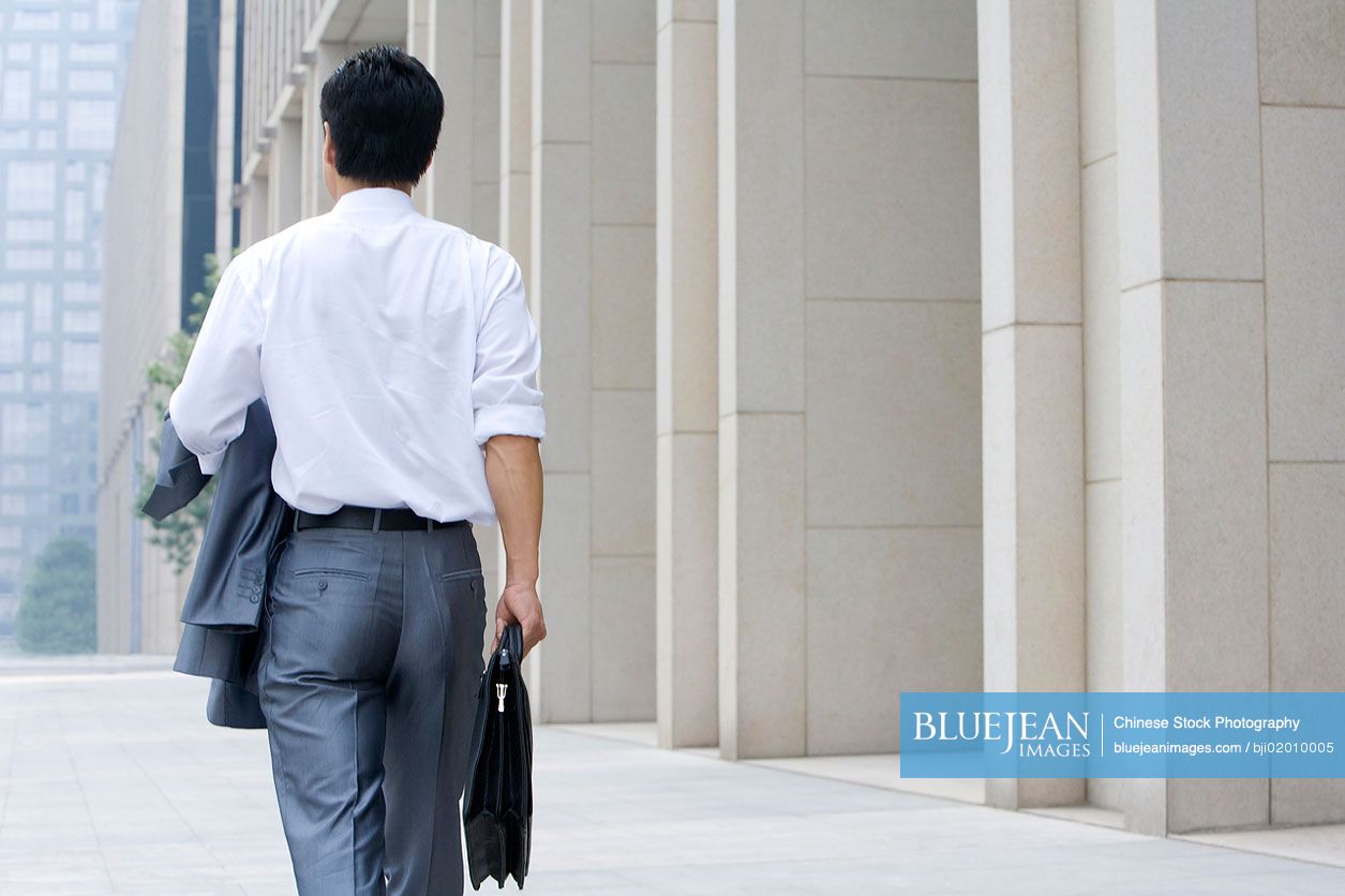 Rear view of Chinese businessman on the move-High-res stock photo for ...