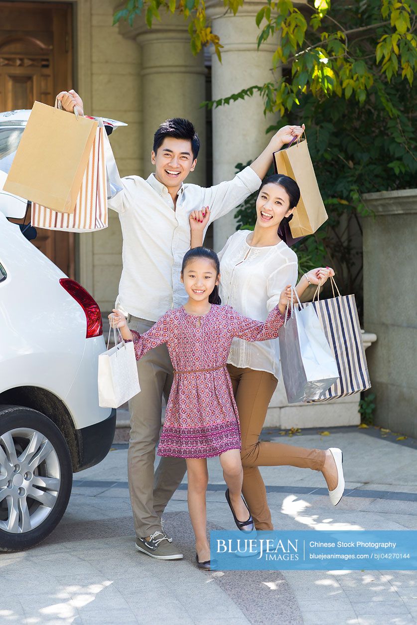 Young Chinese family coming back from shopping-High-res stock photo for ...