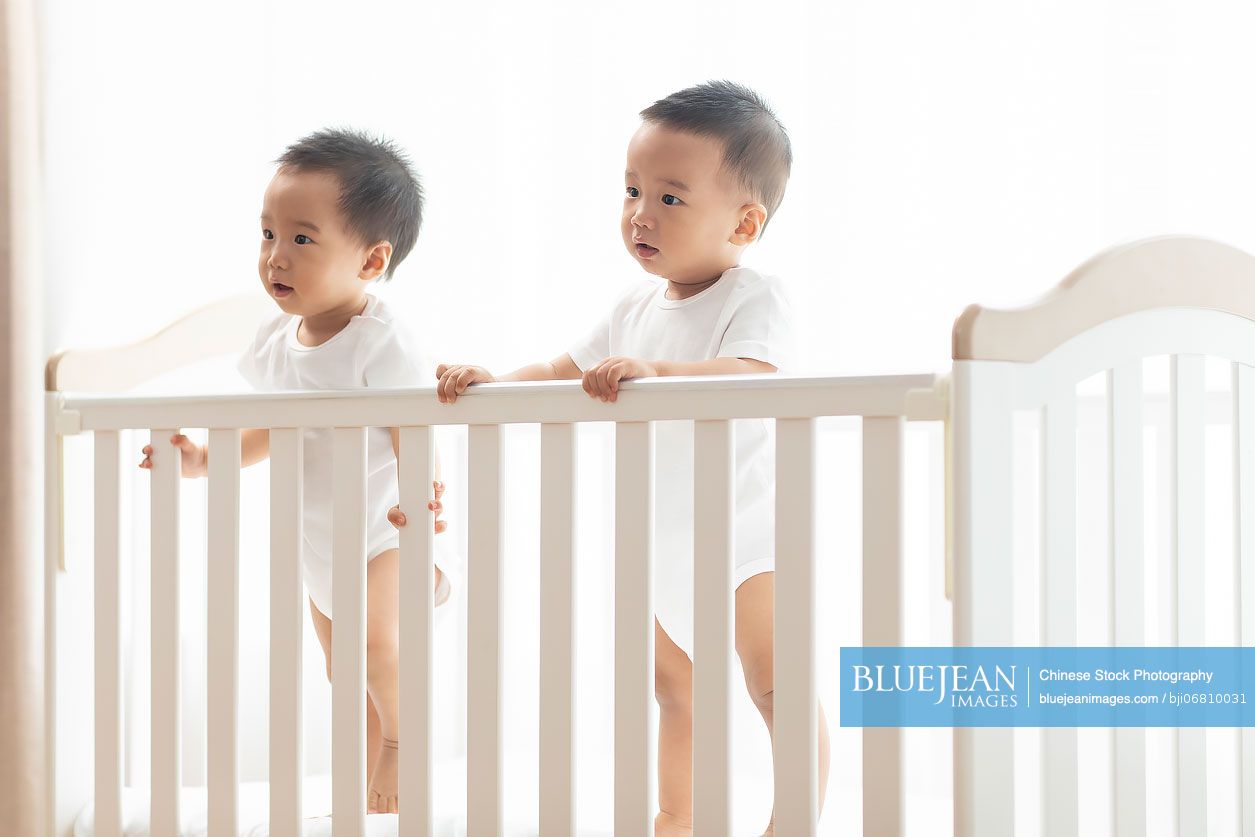 Cute Chinese twin babies playing at home-High-res stock photo for download