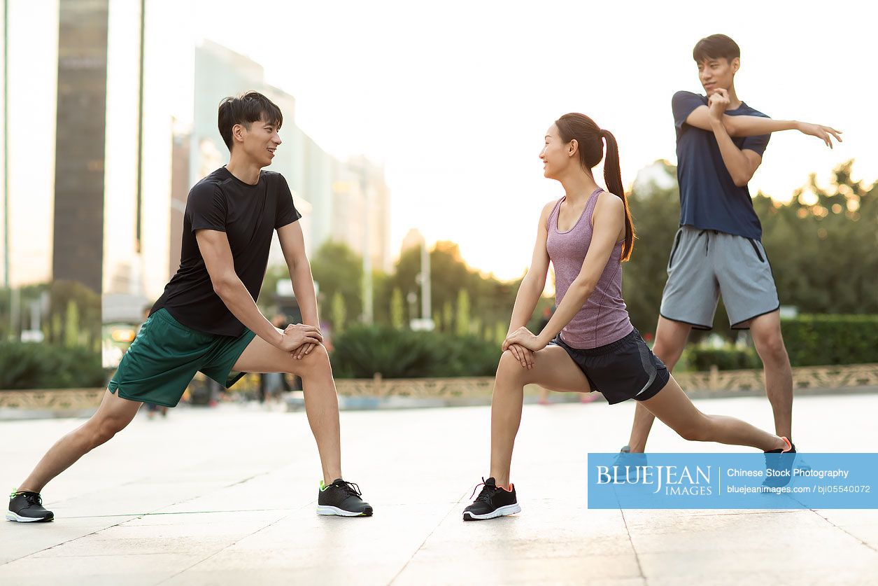 Young Chinese friends warming up outdoors-High-res stock photo for download