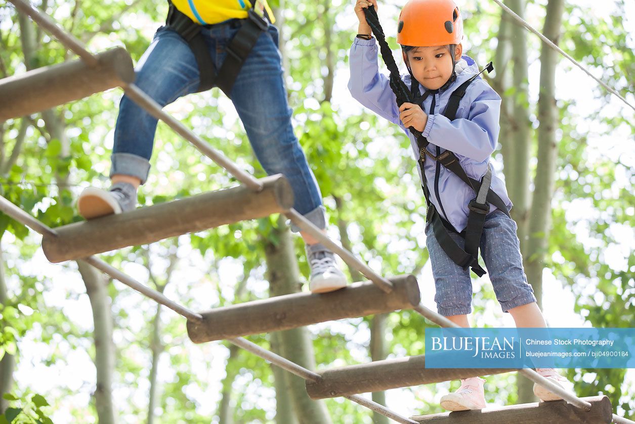 Happy Chinese children playing in tree top adventure park-High-res ...