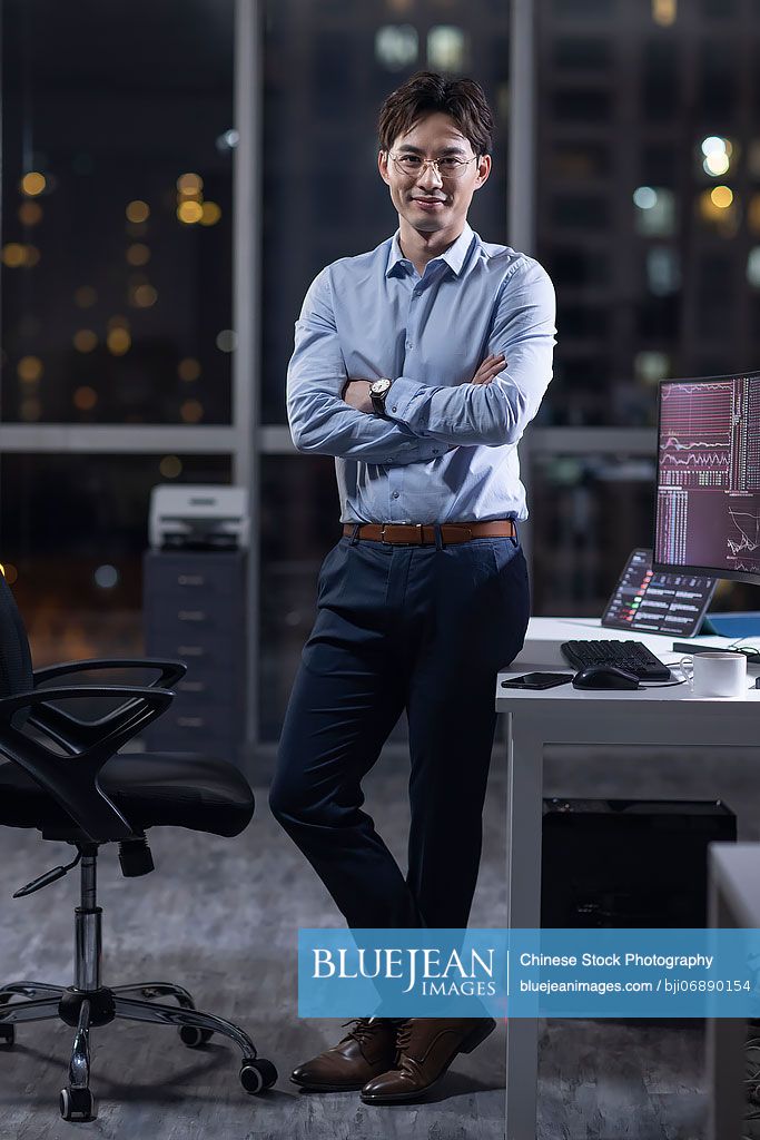 Chinese businessman working in office at night-High-res stock photo for ...