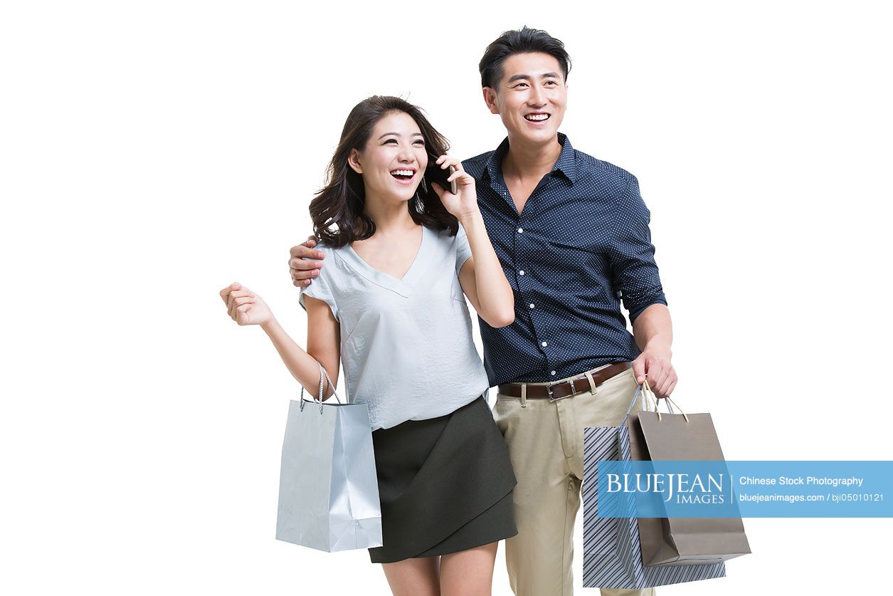 Happy young Chinese couple shopping-High-res stock photo for download