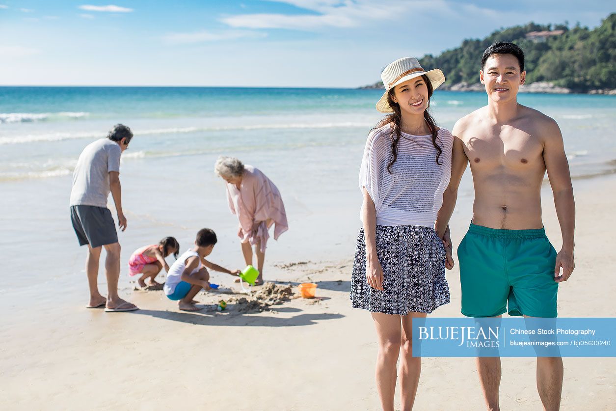 Happy Chinese family having fun on beach-High-res stock photo for download
