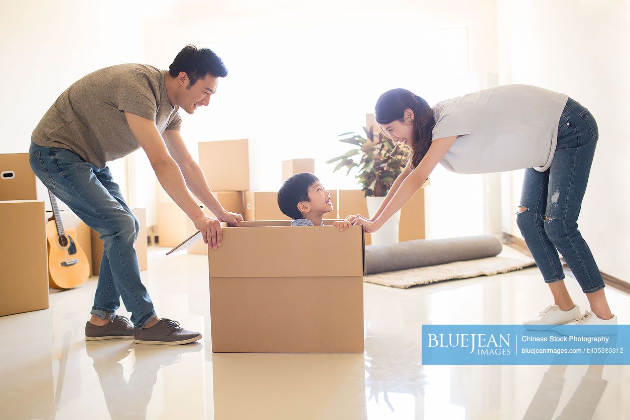 Happy young Chinese family moving to a new house-High-res stock photo ...