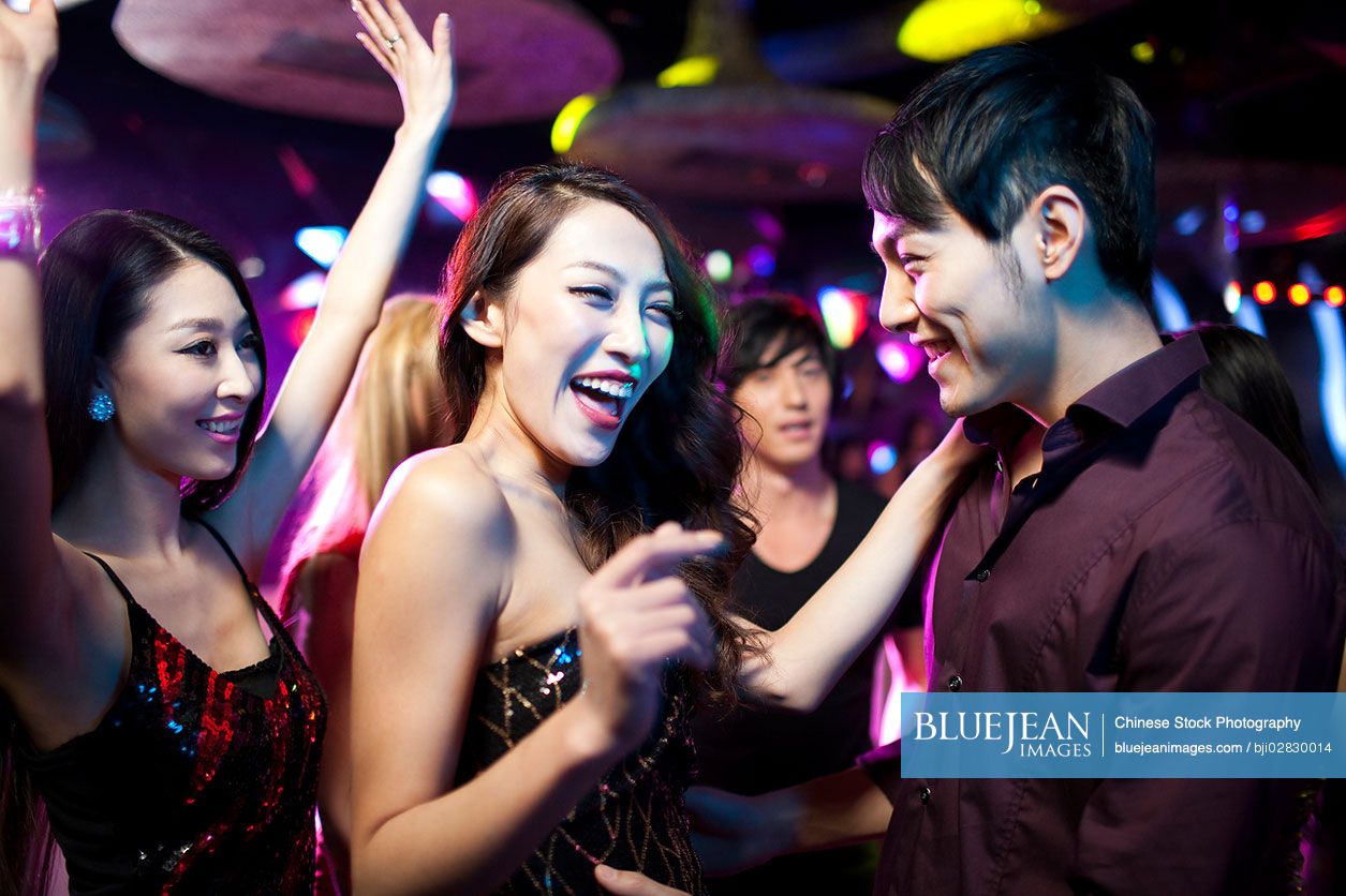 Stylish young Chinese dancing in nightclub-High-res stock photo for ...