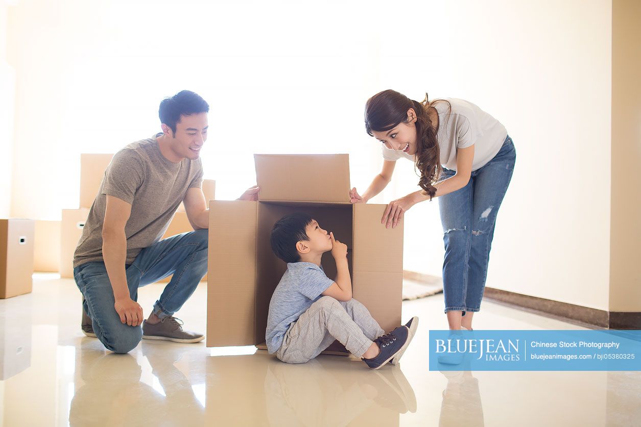 Happy young Chinese family moving to a new house-High-res stock photo ...